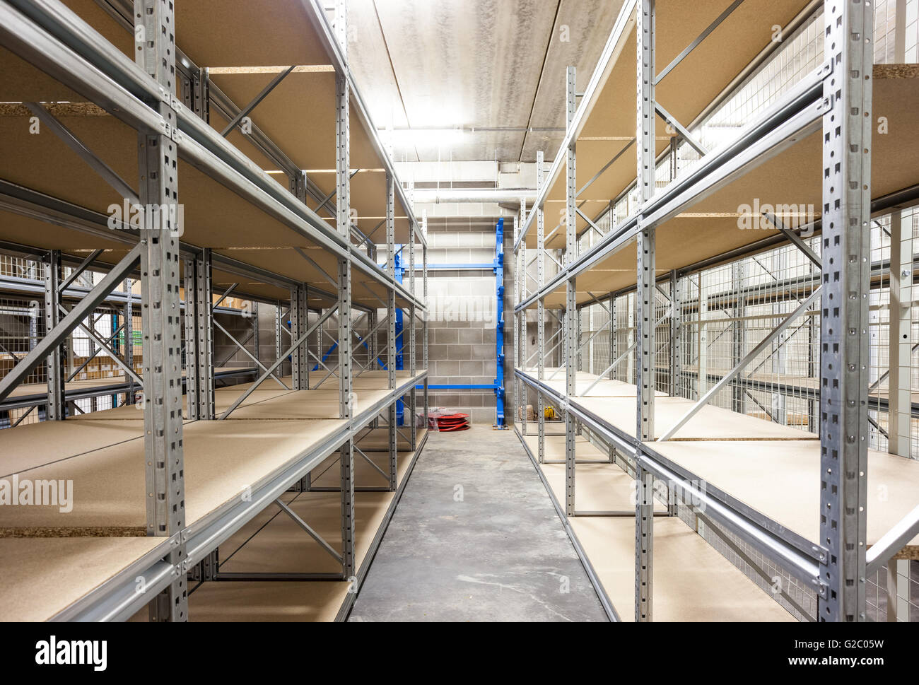 empty storage racks in a building with security Stock Photo - Alamy