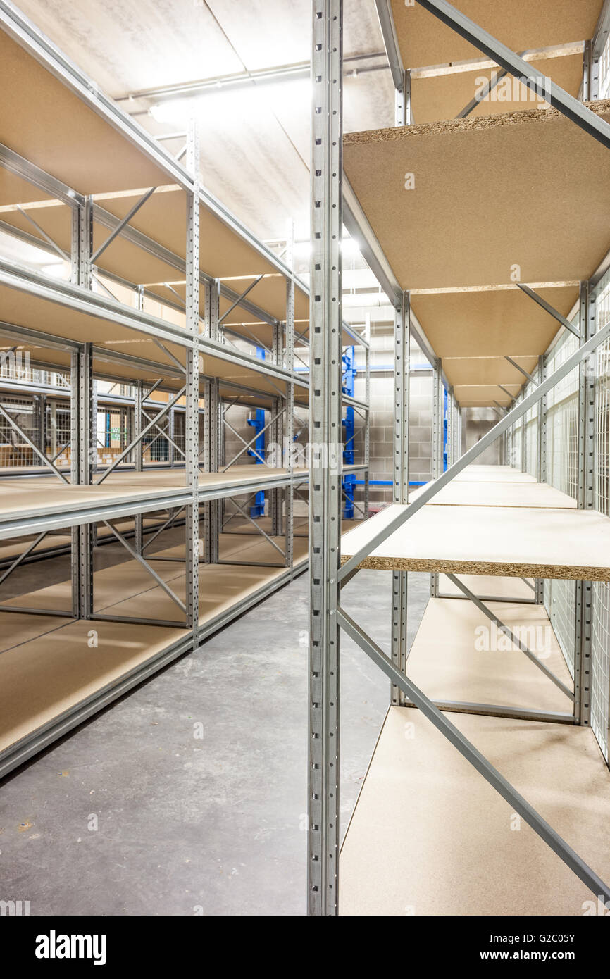 empty storage racks in a building with security Stock Photo - Alamy