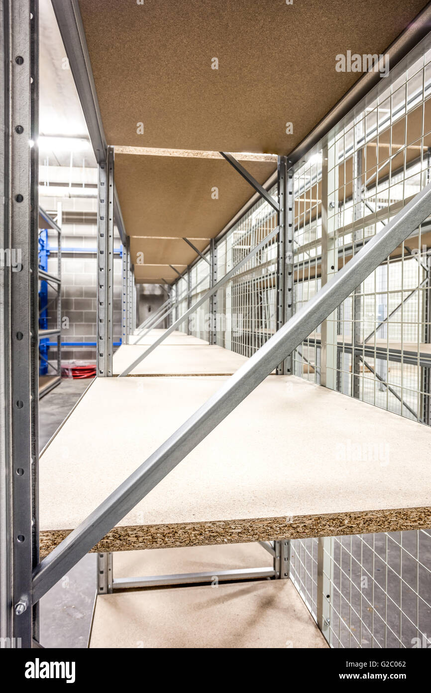 empty storage racks in a building with security Stock Photo - Alamy