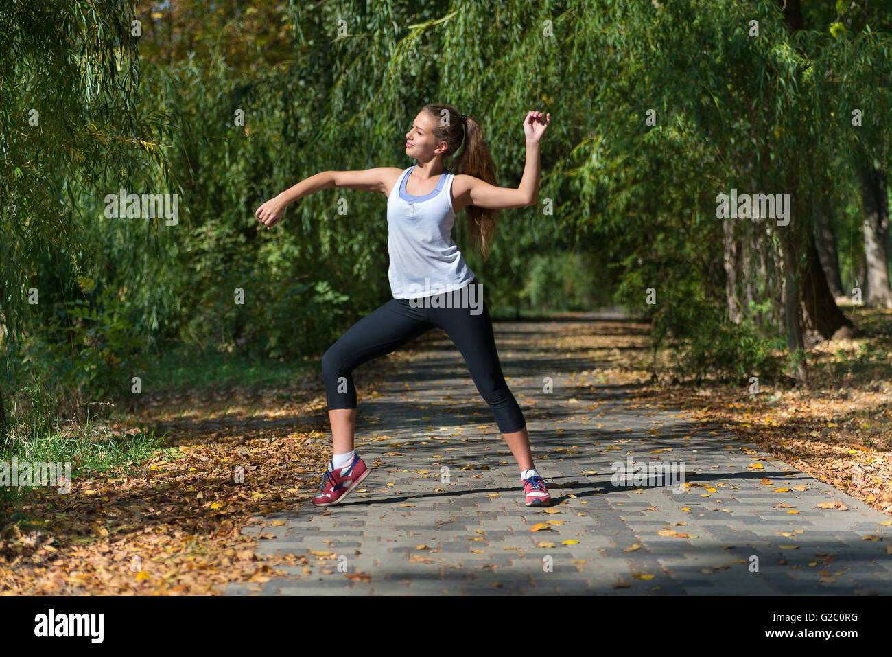 Attractive Woman stretching outdoor Stock Photo - Alamy