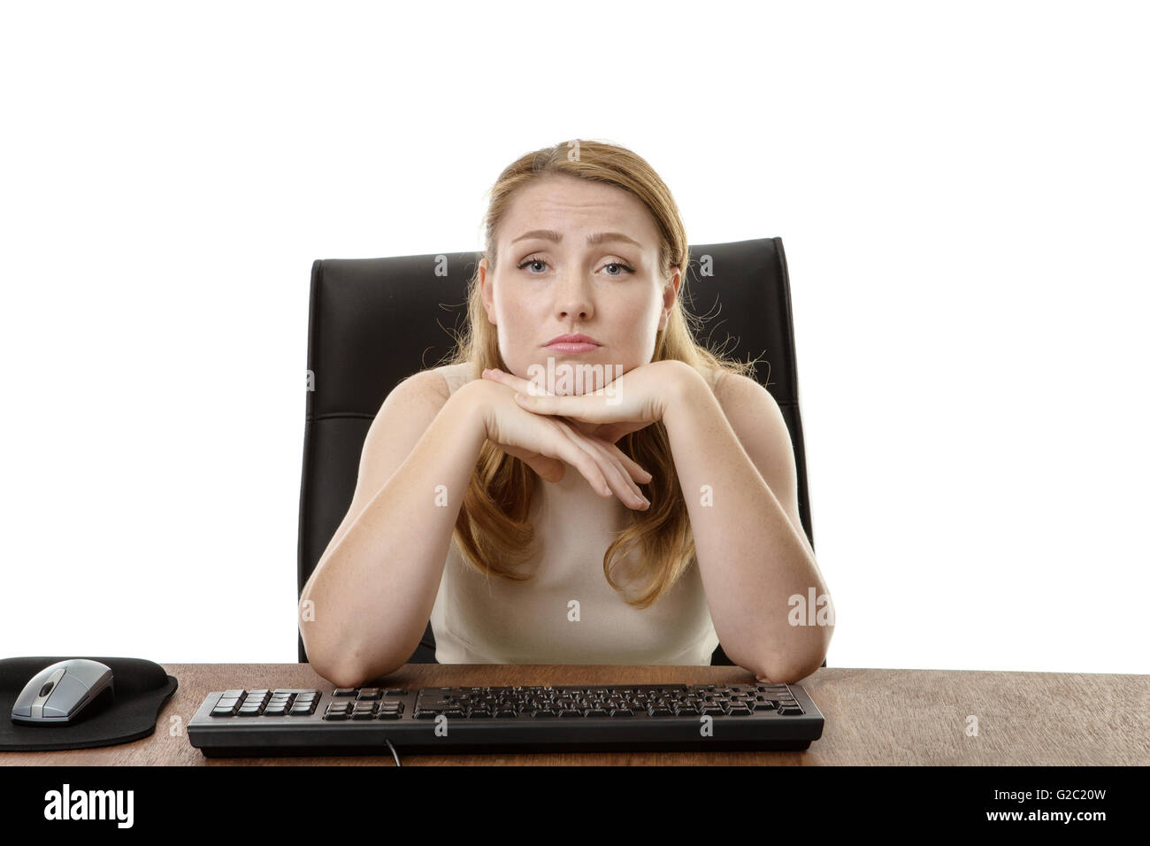 businesswoman at her desk looking bored and uninterested in her work ...