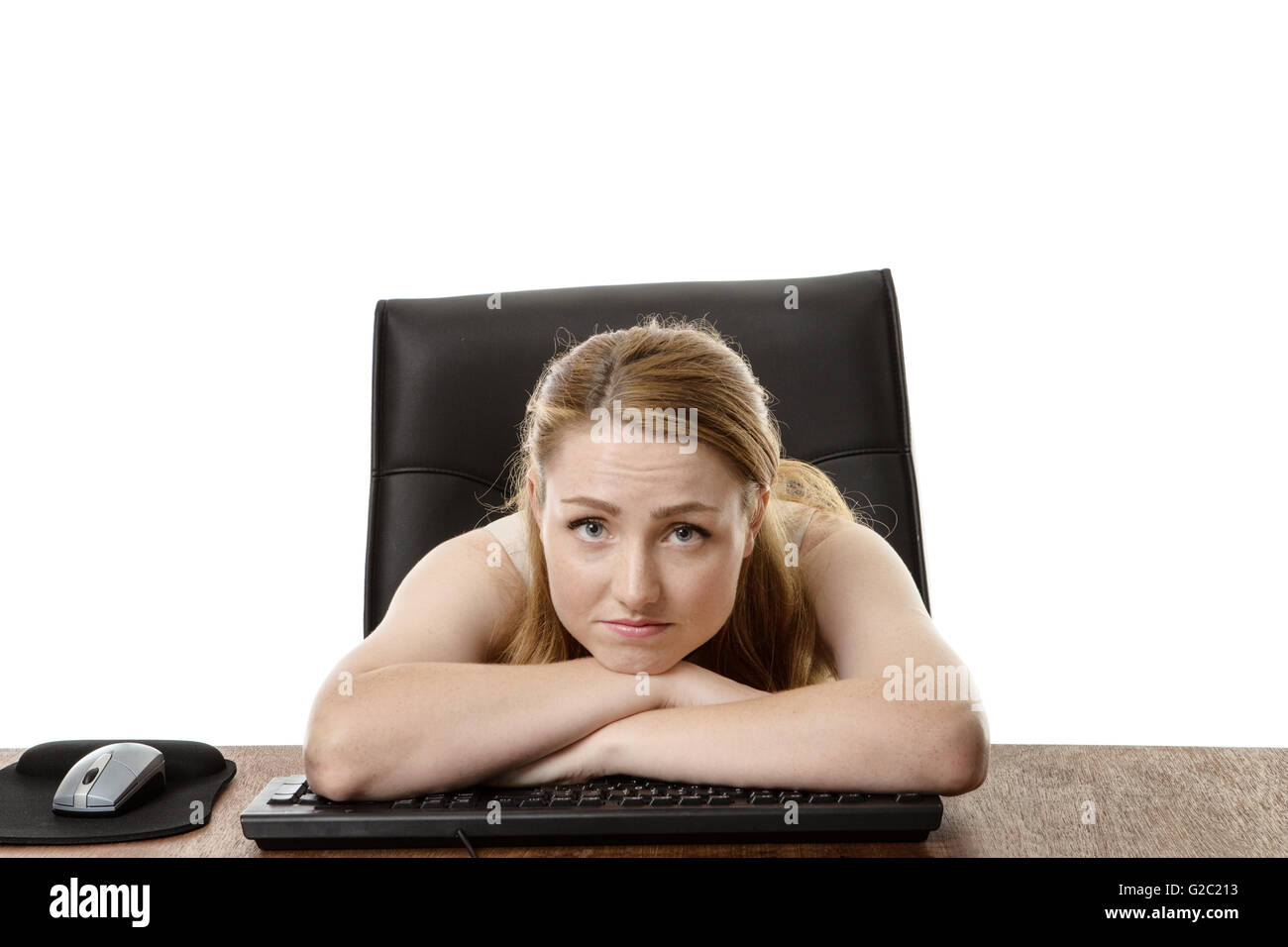 businesswoman at her desk looking bored head down on her keyboard ...