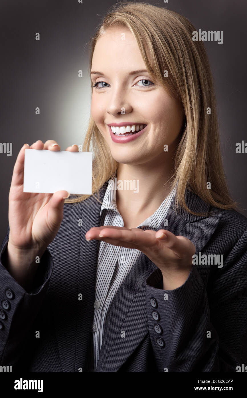 Studio shot of a pretty business model holding a small, white, blank ...
