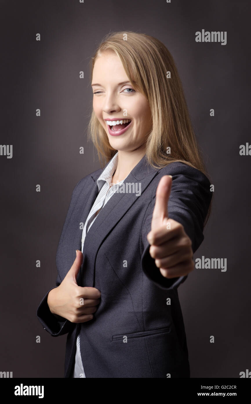 Upper body shot of a business woman showing the thumbs up pose Stock ...