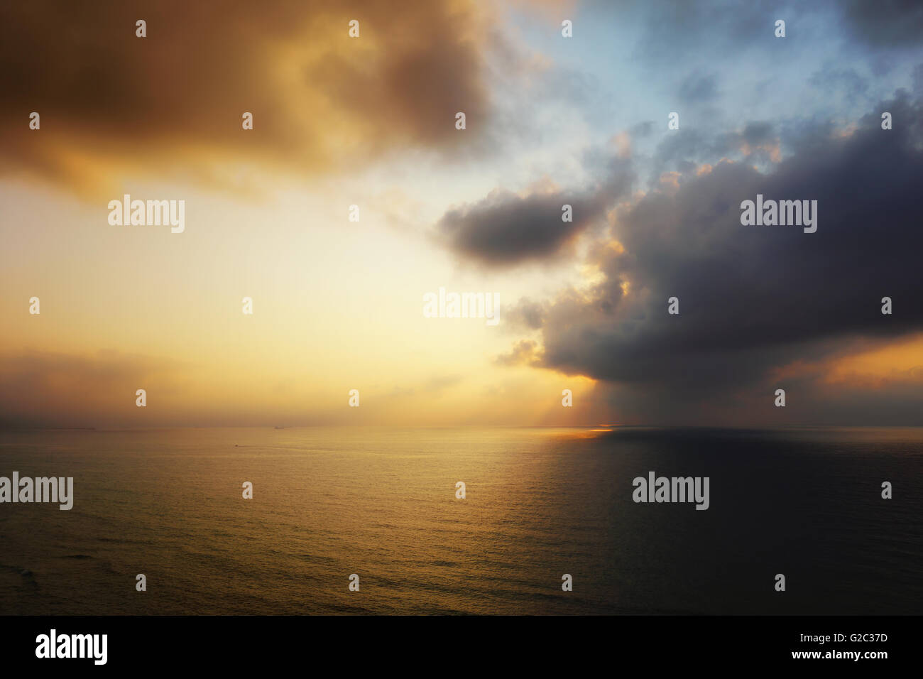 sunset over the sea with sun rays Stock Photo - Alamy