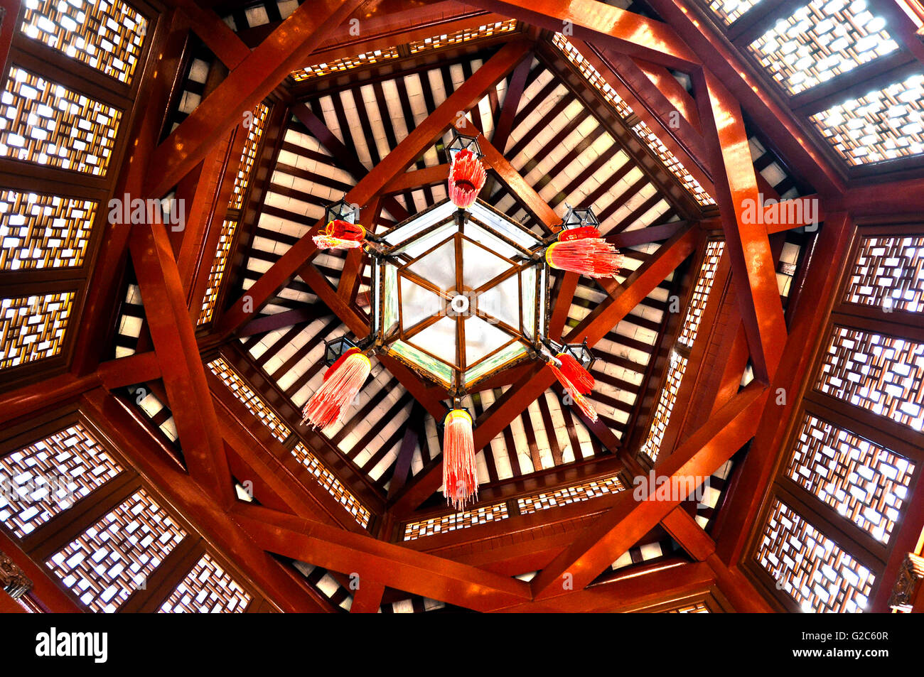 Chinese lantern hanging from wooden beams in the ceiling of an Oriental ...