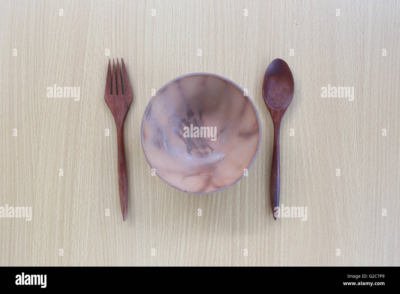 Wooden spoon,fork and dish in top view on wood background for design ...