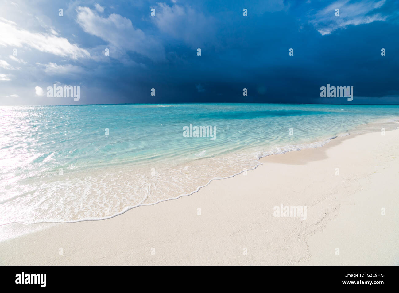 White tropical beach in Maldives with blue lagoon and a tropical storm ...