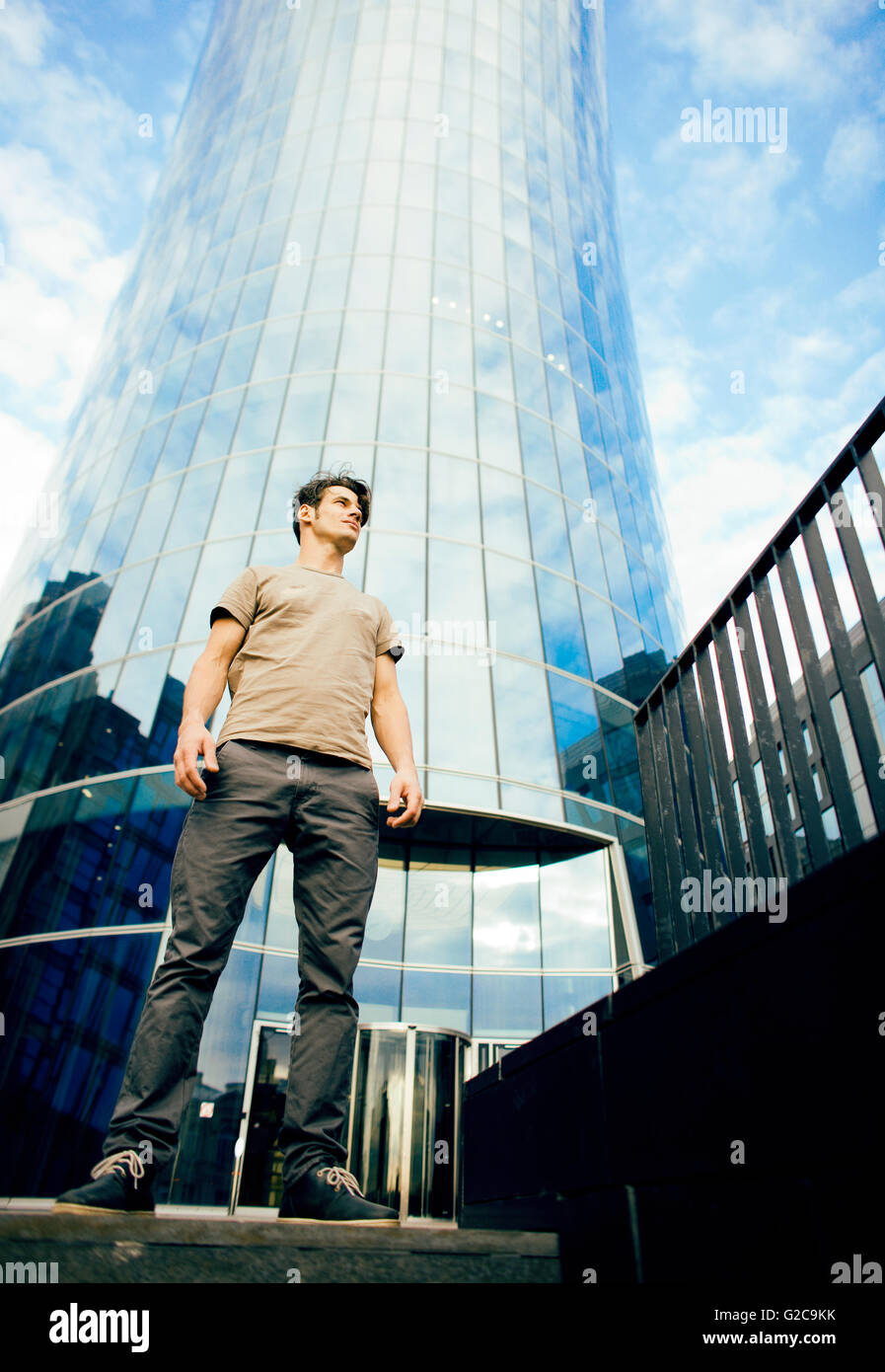 real young man stand in front of modern business building Stock Photo ...