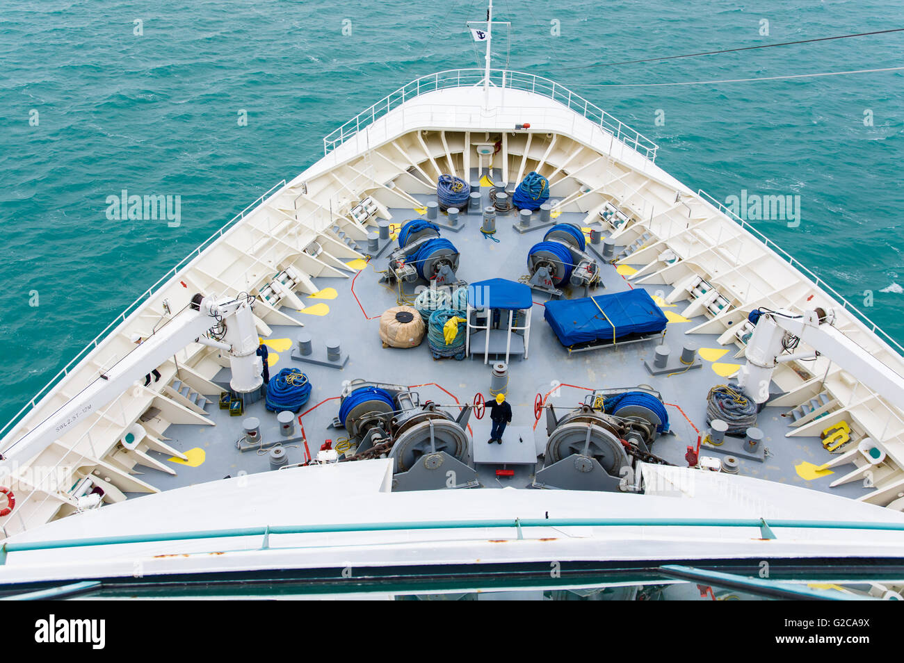 Deck hand prepares to lower the anchor of the Vision of the Seas cruise ...
