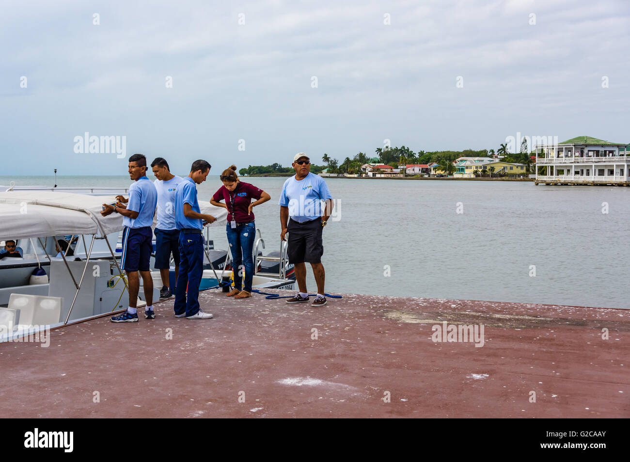 Tour guides waiting for tourists at an excursion boat in Belize City ...