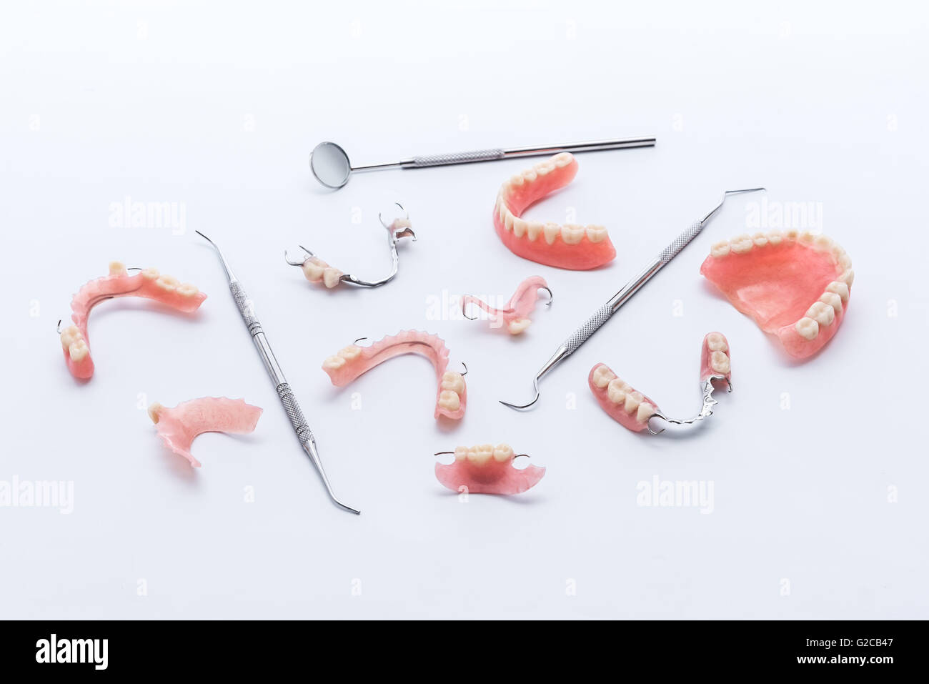 Set of dentures and dental tools on white background Stock Photo - Alamy
