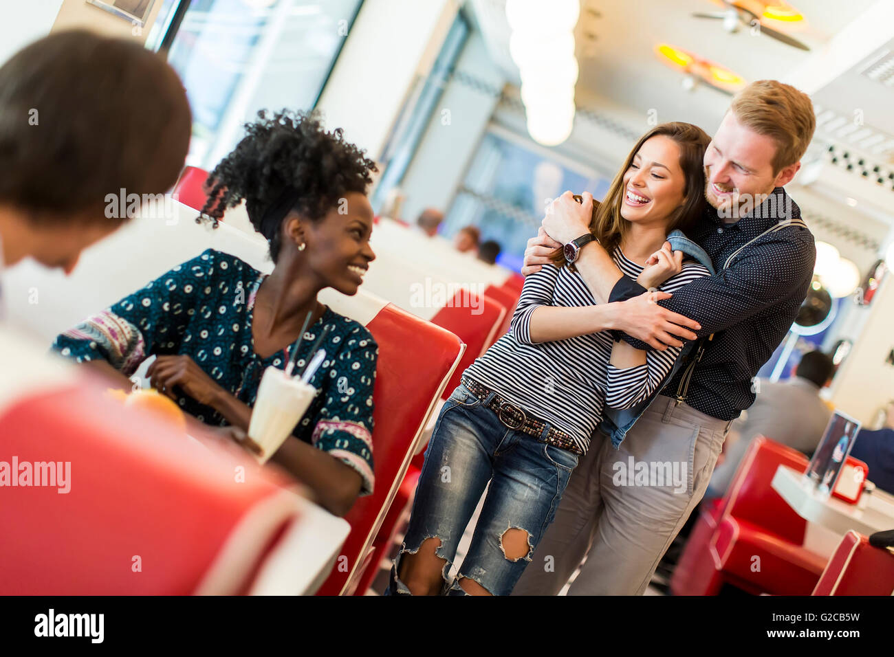 Couple hugging by the table in the diner Stock Photo - Alamy