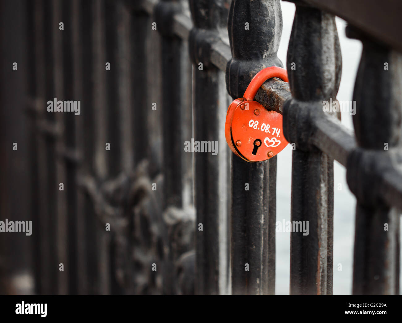 Closed red padlock in the form of heart locked on bridge Stock Photo ...