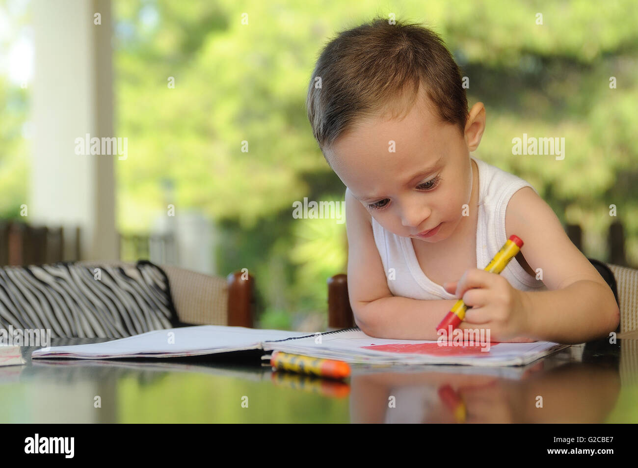 child drawing in a notebook in a summer school Stock Photo - Alamy