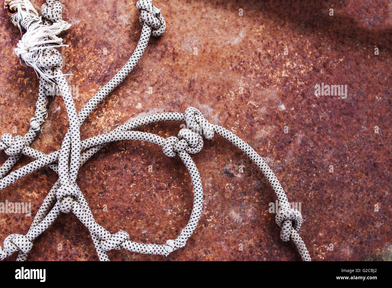 Old Hemp rope on rusty metal background Stock Photo - Alamy