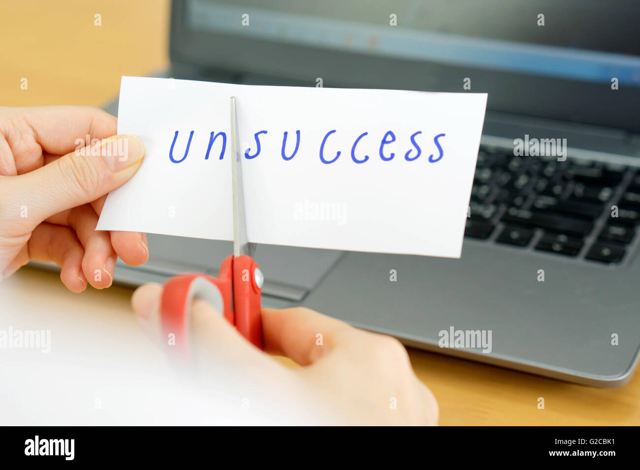 holds card with text unsuccess on computer Stock Photo - Alamy