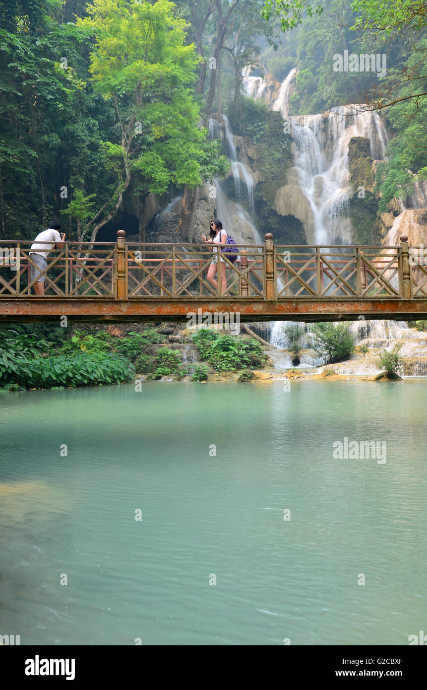 People on bridge looking and take photo with viewpoint of Kuang Si ...