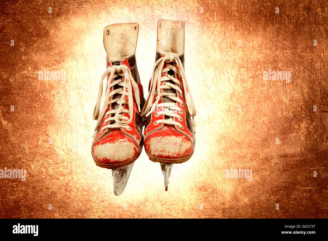 pair of red black colored ice skates, retro textured leather background ...