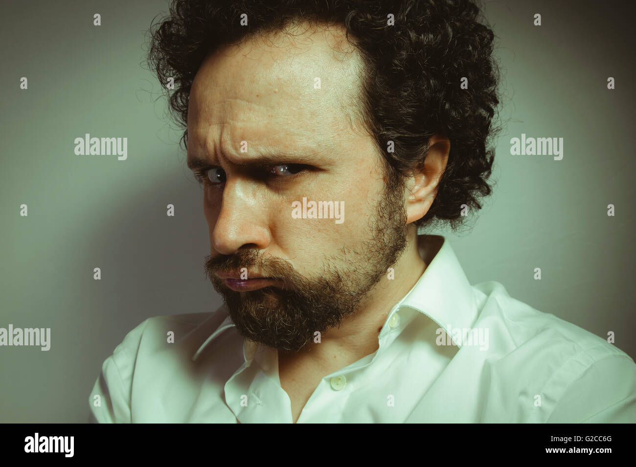 sad face, man with intense expression, white shirt Stock Photo - Alamy
