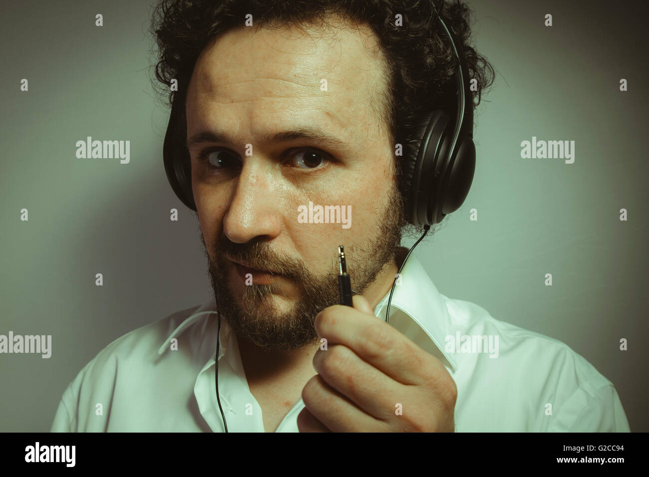 hate music, man with intense expression, white shirt Stock Photo - Alamy