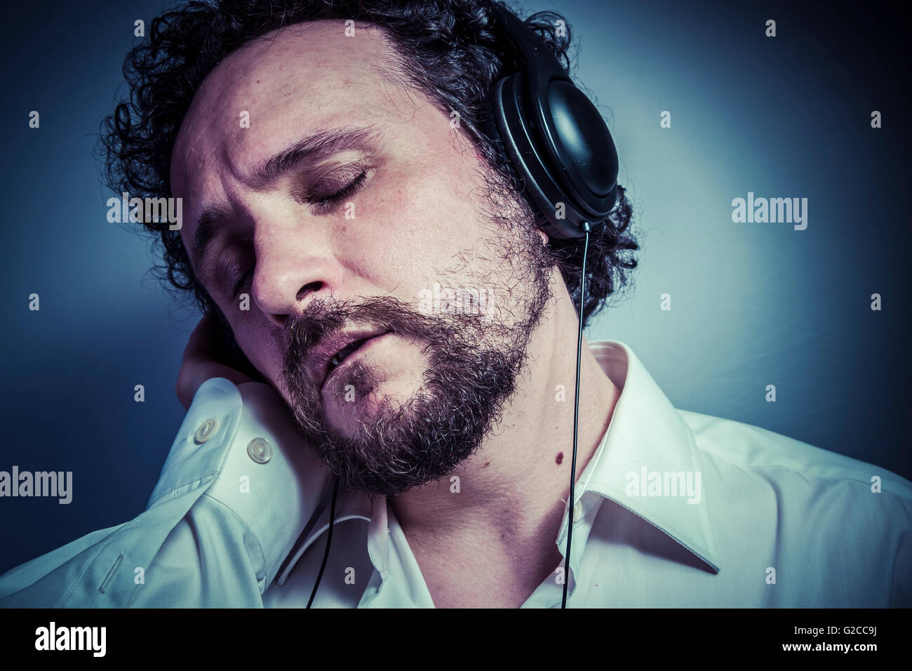 enjoy the music, man with intense expression, white shirt Stock Photo ...