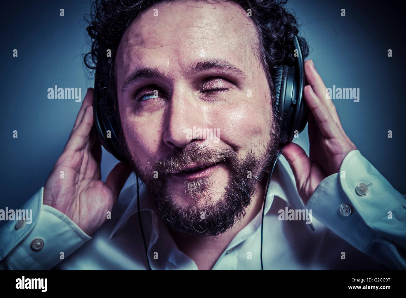 enjoy the music, man with intense expression, white shirt Stock Photo ...
