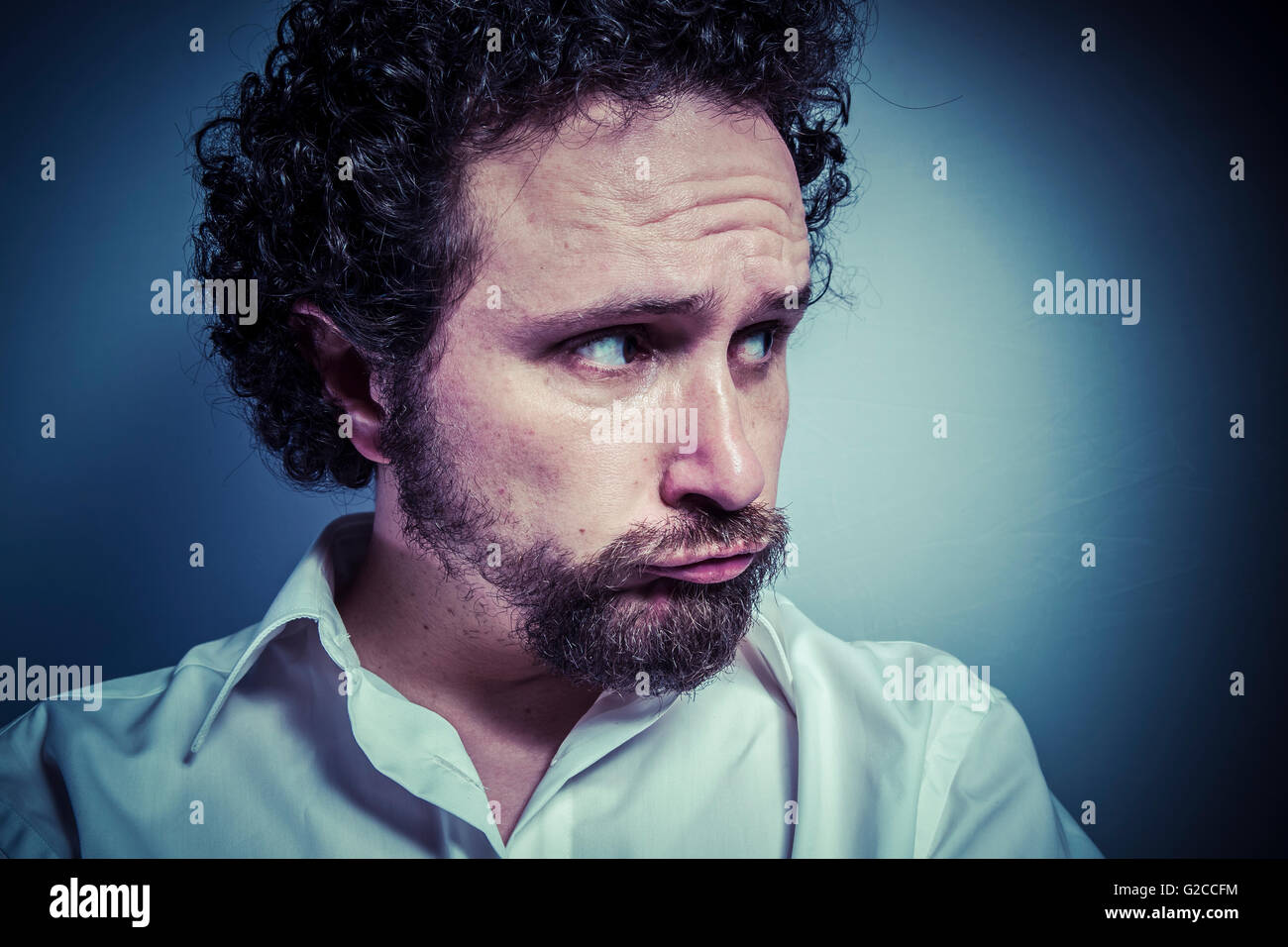 sad face, man with intense expression, white shirt Stock Photo - Alamy