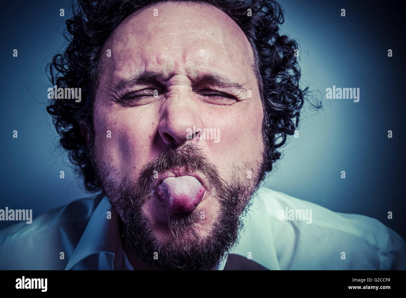 derision, man with intense expression, white shirt Stock Photo - Alamy