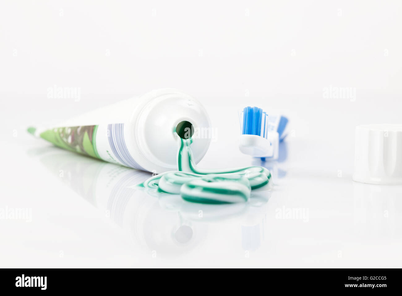 dental hygiene stuff, with sqeezed out toothpaste on paste tube and ...