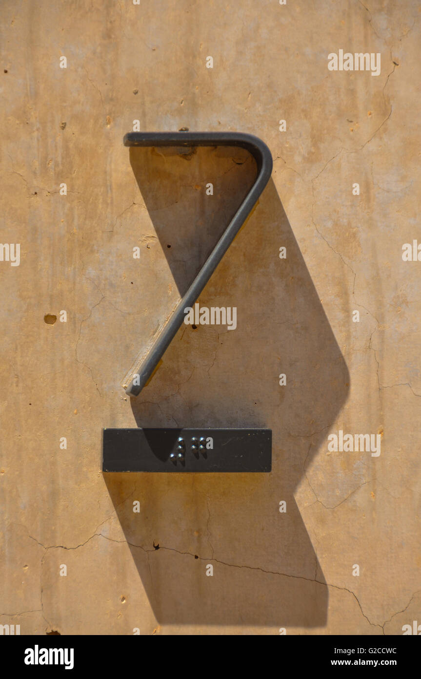 number 7 in bronze, with the name of number seven in braille below ...