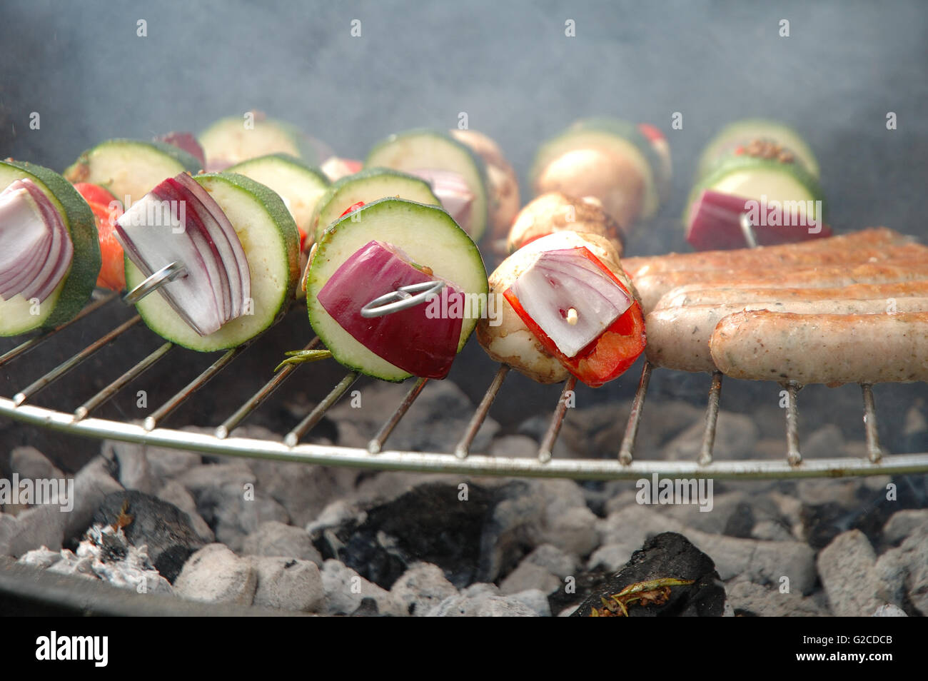 shish-kebab and sausages cooking on barbecue Stock Photo - Alamy