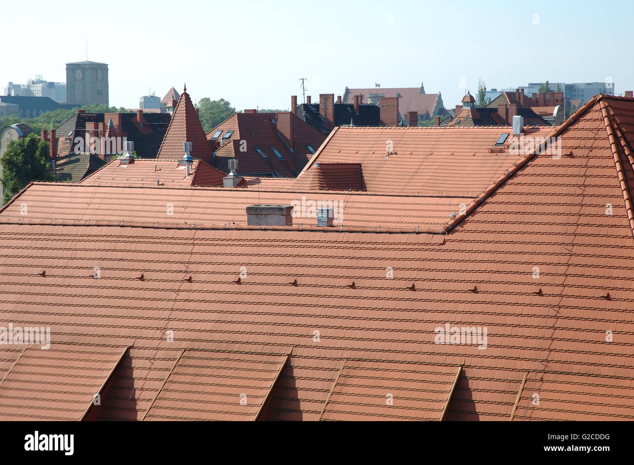 Tiled roofs, chimneys and windows on old buildings in Poznan in Poland ...