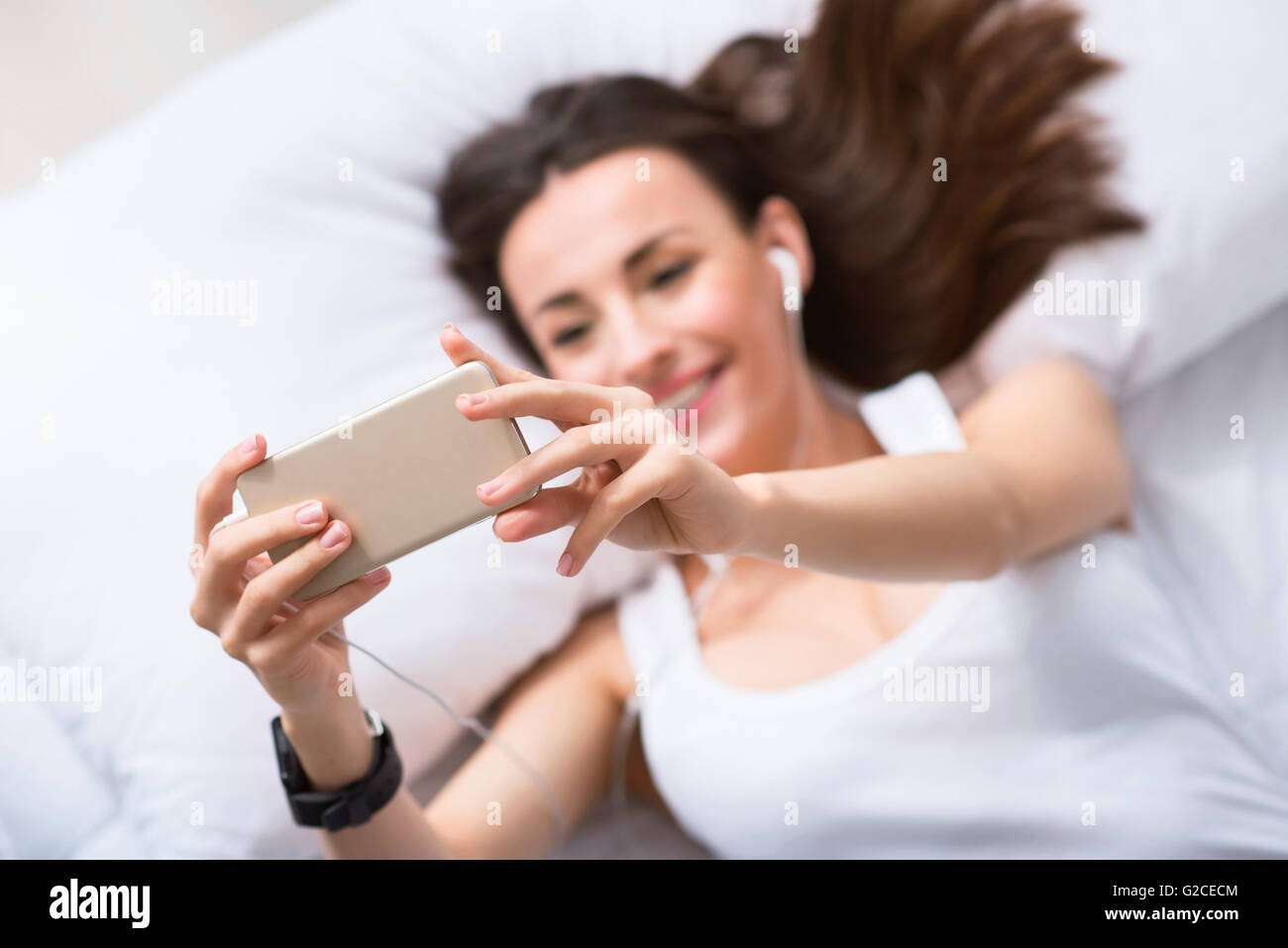 Cheerful beautiful woman resting in bed Stock Photo - Alamy