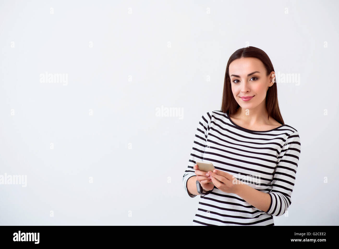 Pleasant woman standing isolated on white background Stock Photo - Alamy