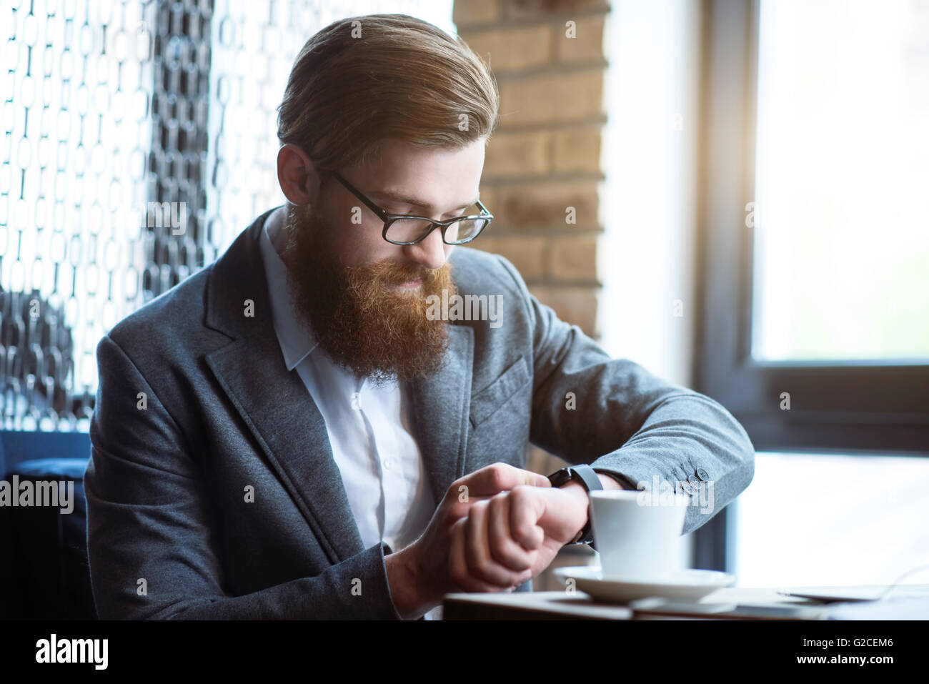 Positive bearded man drinking coffee Stock Photo - Alamy