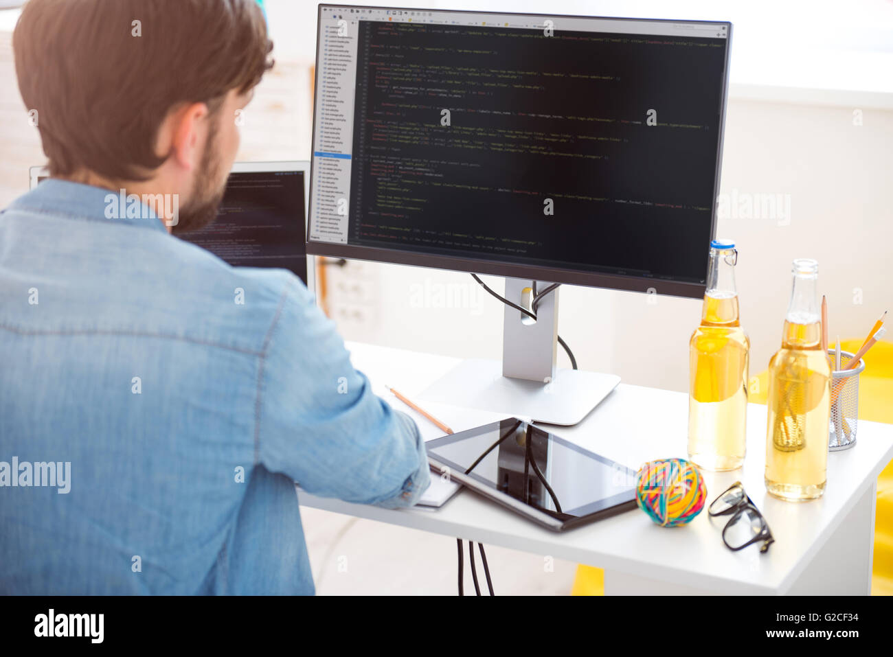 Man looking at the screen of computer Stock Photo - Alamy