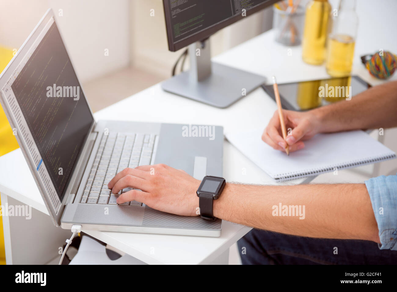 Hands of man tapping on the laptop Stock Photo - Alamy