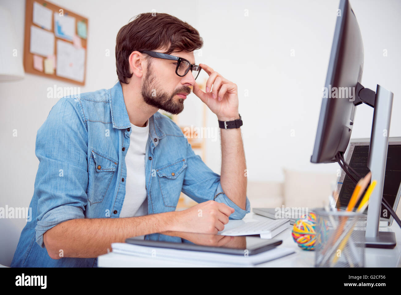 Man looking at screen of computer Stock Photo - Alamy