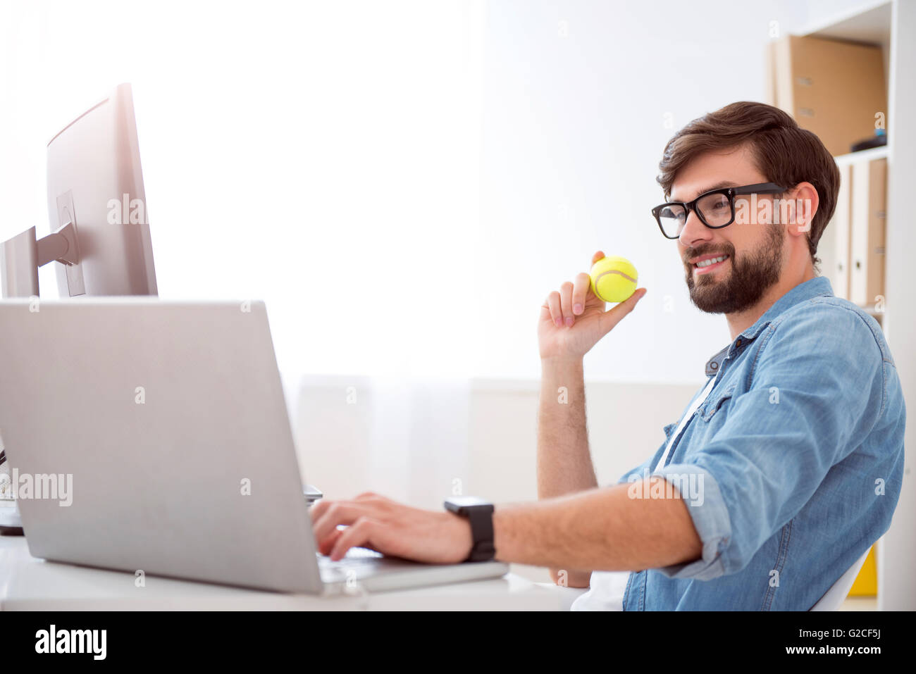 Guy working on his computer Stock Photo - Alamy