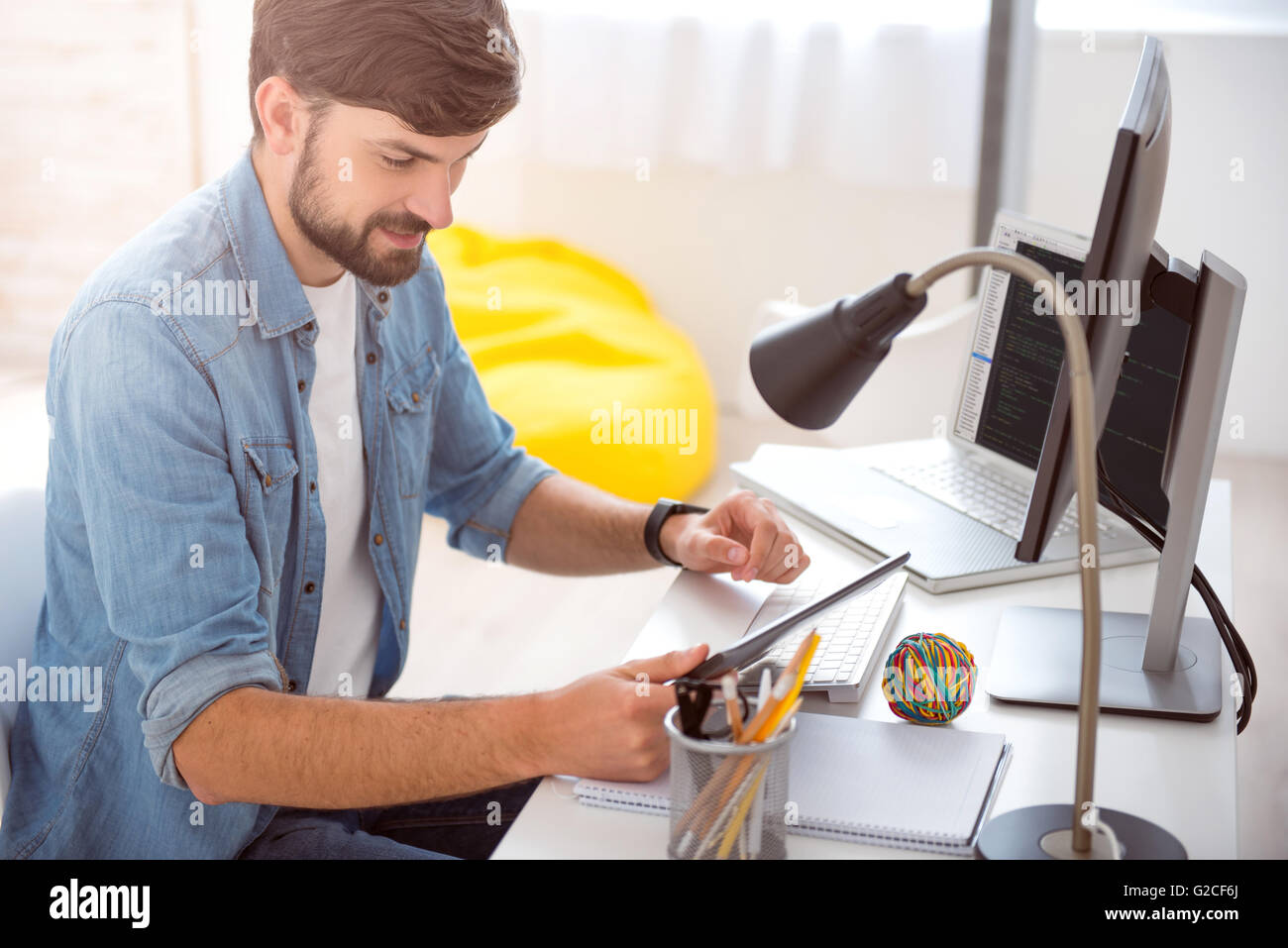 Man looking at his tablet Stock Photo - Alamy