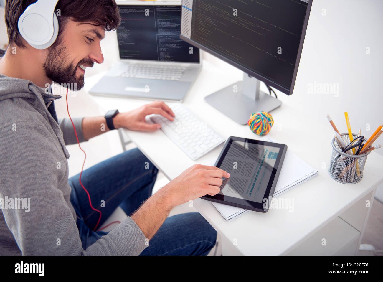Man looking at his tablet Stock Photo - Alamy