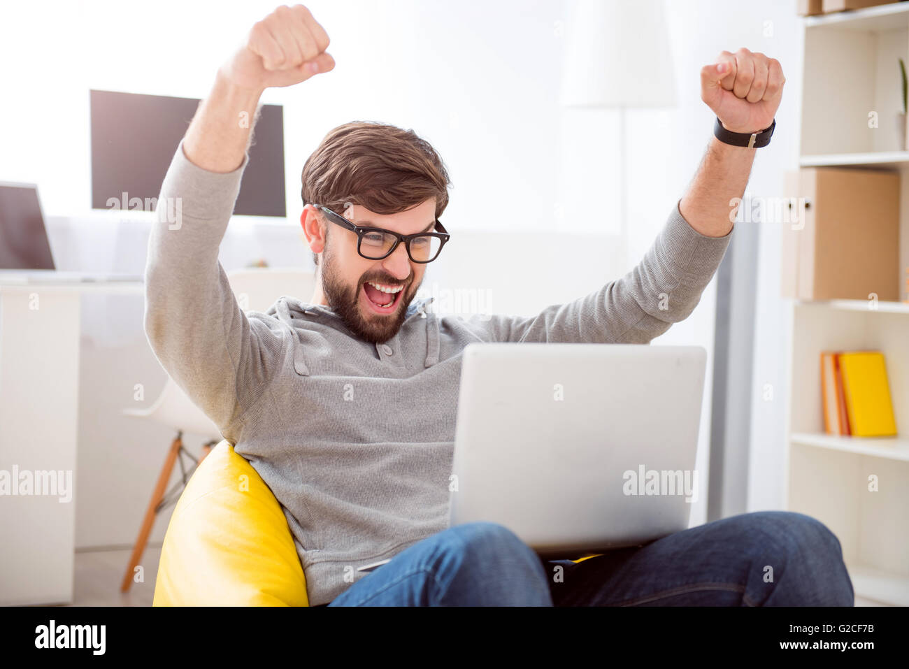 Man raising hands in sign of victory Stock Photo - Alamy