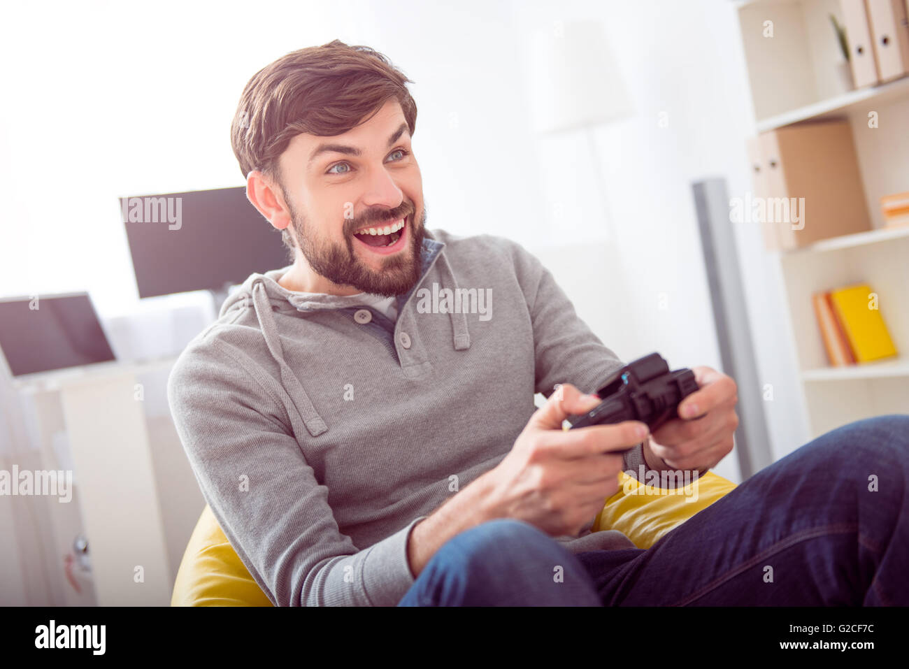 Man playing videogames and holding joystick Stock Photo - Alamy