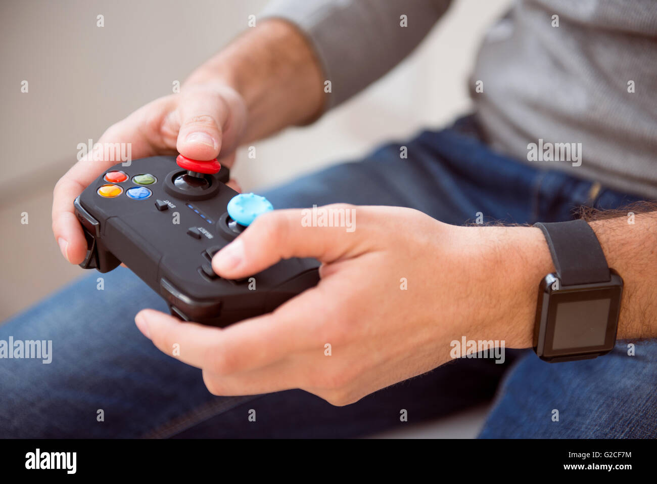 Man holding joystick of game console Stock Photo - Alamy