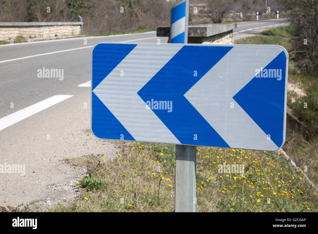 Blue and White Bend in Road Warning Sign Stock Photo - Alamy
