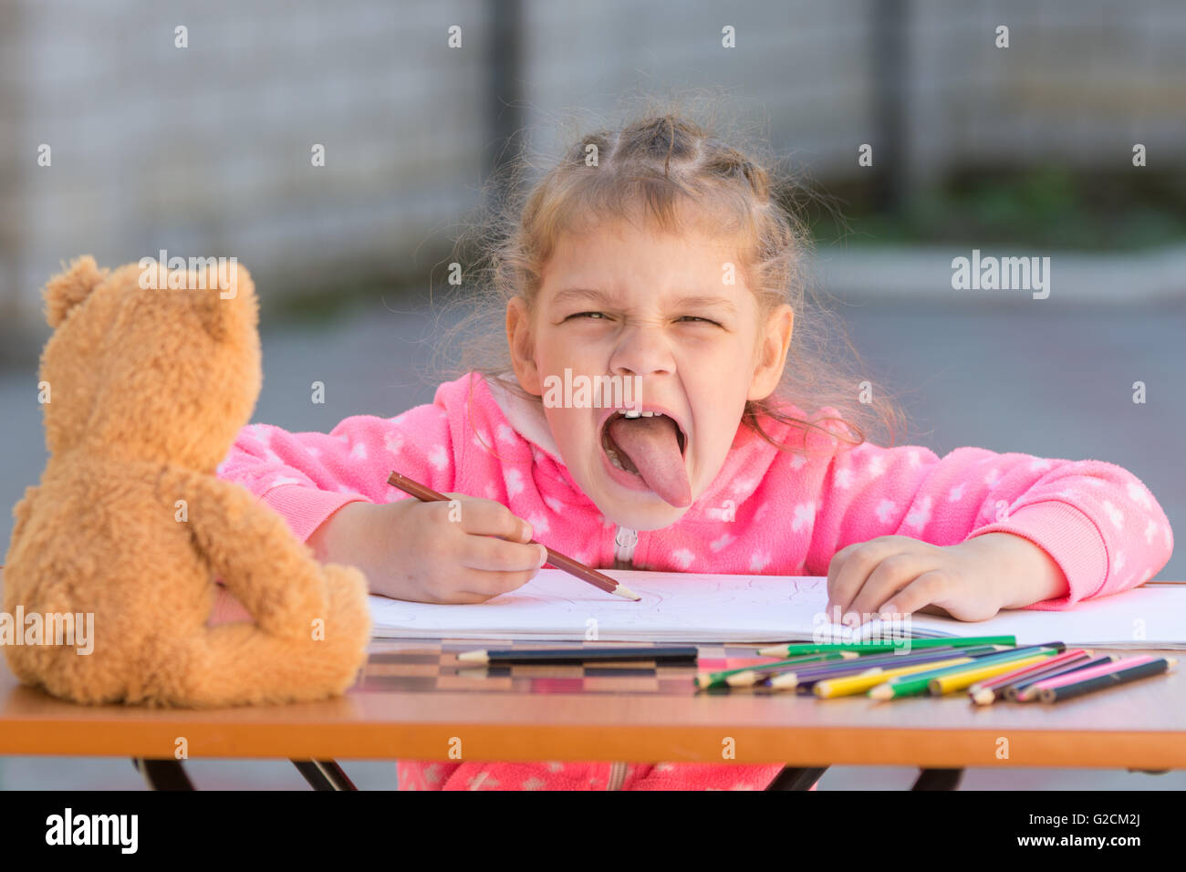 Girl shows the language in the frame drawing in the yard Stock Photo ...