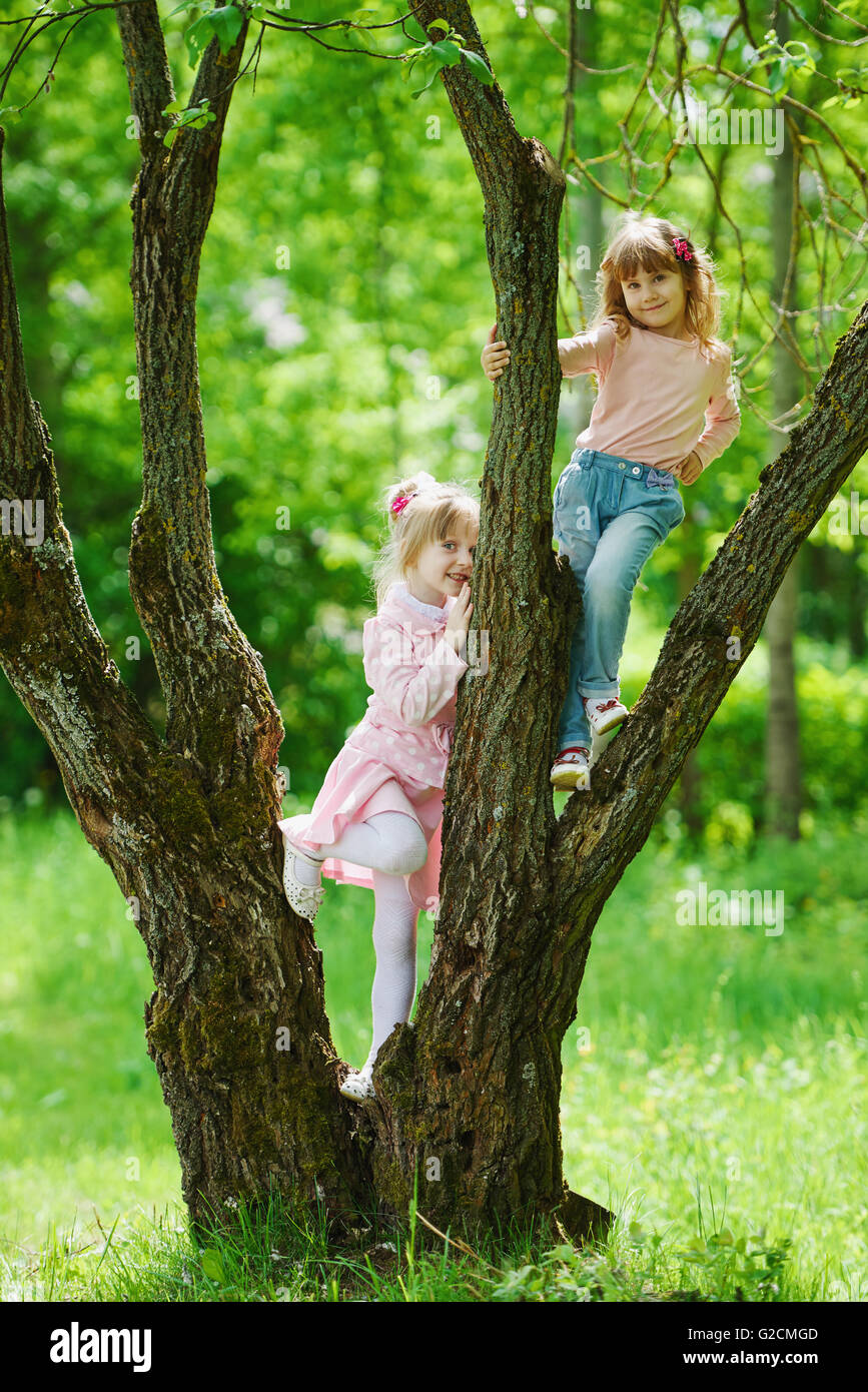 little girls climbing to the tree Stock Photo - Alamy