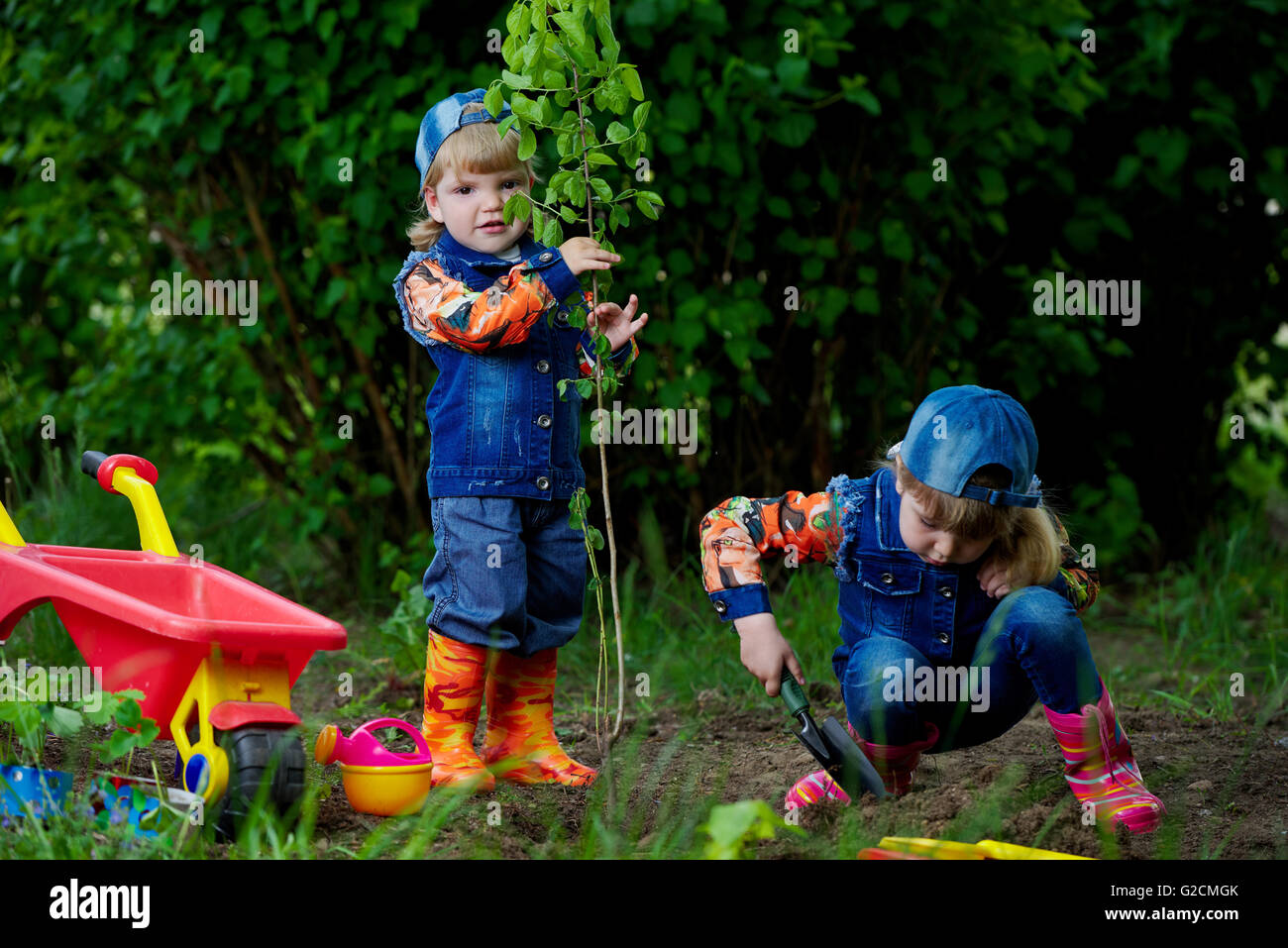 happy girls planting tree Stock Photo - Alamy