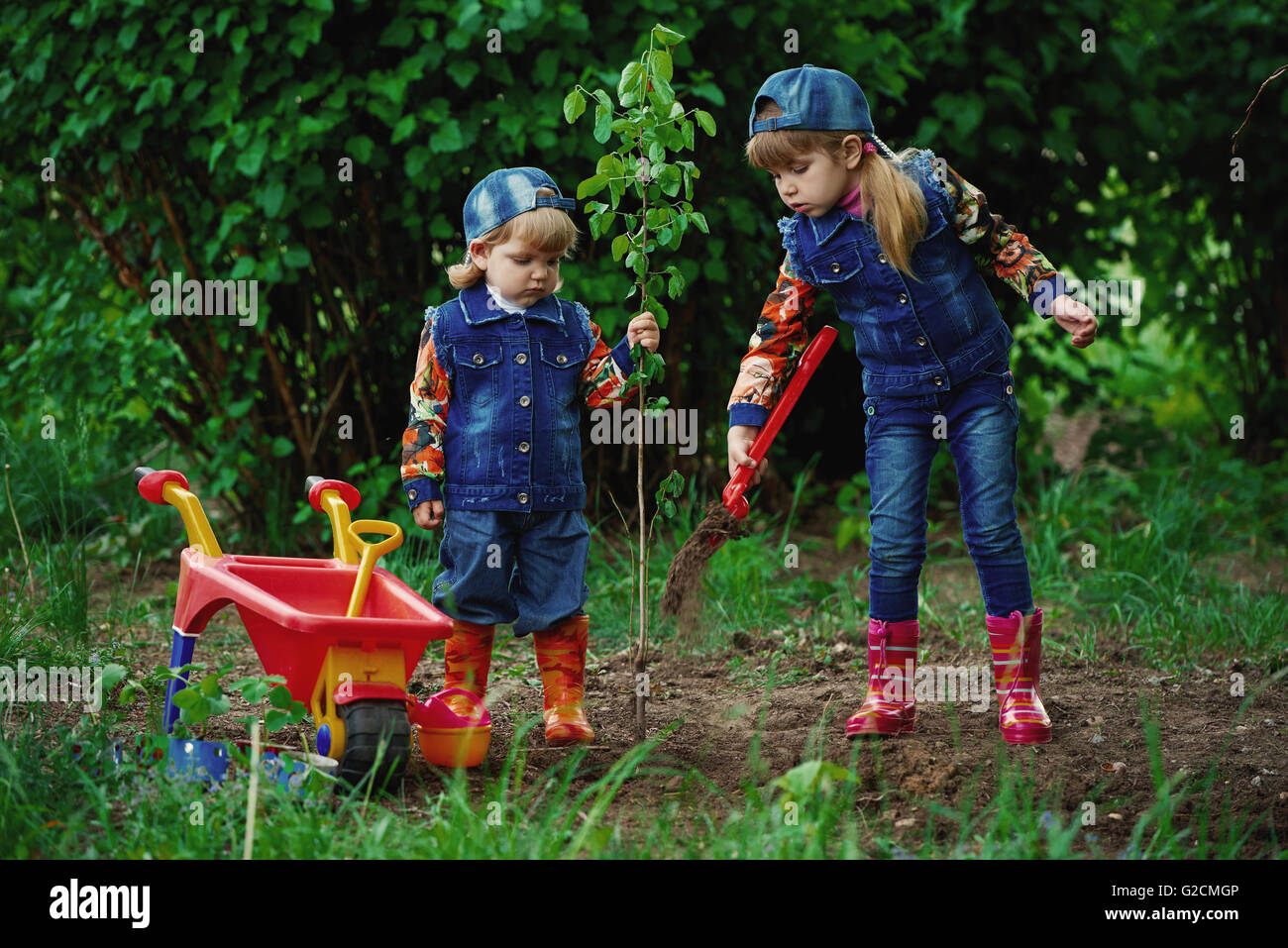 happy girls planting tree Stock Photo - Alamy